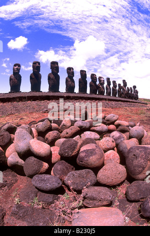 A row of stone statues are lined up on a ledge. The statues are all ...