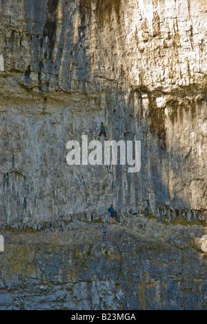 People rock climbing on Malham Cove, a spectacular limestone crag ...