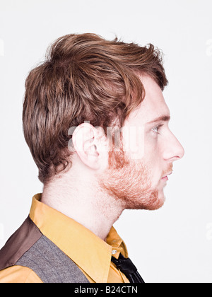 Serious young man with ginger hair frowning, showing stop gesture ...