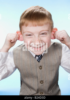 Studio portrait of boy pulling his ears Stock Photo - Alamy