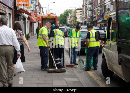 A local council road sweeper and pavement sweeper vehicle, cleaning a ...