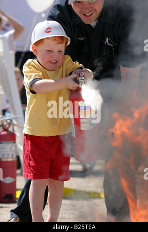 Man Using Fire Extinguisher To Put Out Fire From Oven At Home Stock ...