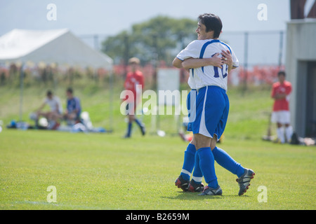 Two soccer players celebrating Stock Photo - Alamy