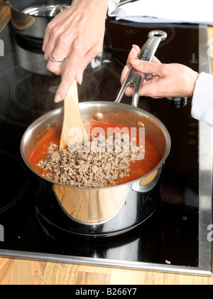 Woman preparing meat lasagna in kitchen. lasagna recipe - Italian food ...