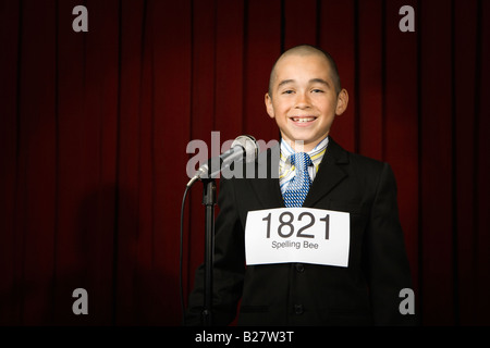 Boy standing on stage with microphone and big eyes Stock Photo - Alamy