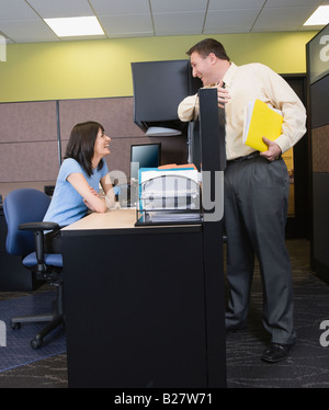 View over an cubicle wall of office workers by copy machines Stock ...