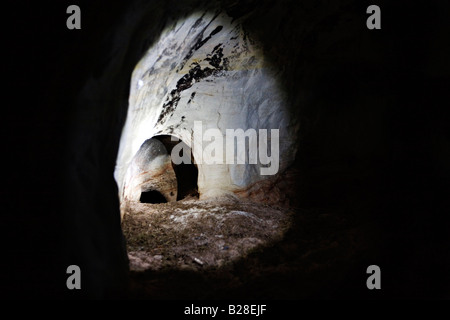 sandstone cave entrance in dark. sand covered ground. latvia Stock ...
