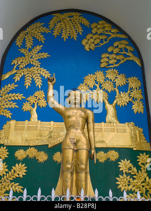 Golden statue of standing Buddha in the jungle, on the way to the top ...
