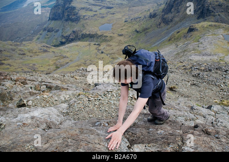 Female hiker climbs steep ridge to summit of Bla Bheinn (Blaven), Black ...