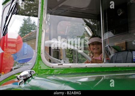 Little girl driving bus London UK Stock Photo - Alamy