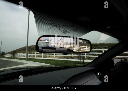 Traffic police through the rear view mirror of a car that they have ...