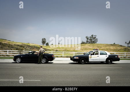 Two police officers approach a suspect Ferrari at DUI checkpoint Stock ...