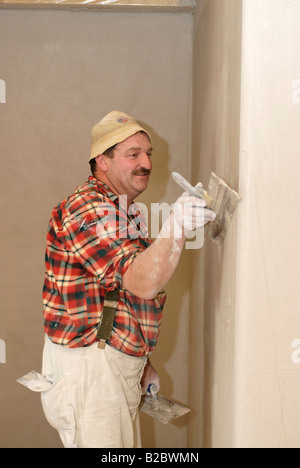 Plasterer at work, wave-like plaster, house construction, brickwork ...