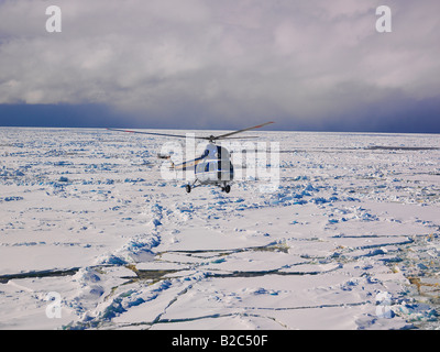 Helicopter over ocean ice, Antarctic Stock Photo - Alamy