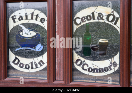 Stained glass signs on Irish pub window, Doolin County Clare, Ireland ...