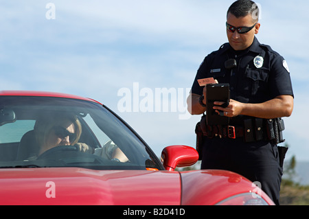 Traffic cop standing by sports car Stock Photo - Alamy