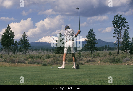 A golfer tees off at one of Bend Oregon s numerous golf courses on the ...
