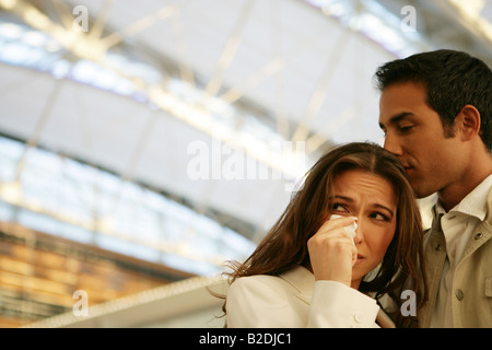 Sad couple in airport saying goodbye Stock Photo - Alamy