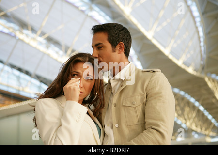 Sad couple in airport saying goodbye Stock Photo - Alamy