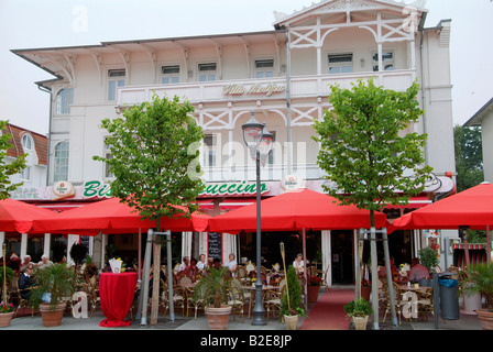 Sitting at a roadside cafe in central Paris Drinking coffee reading ...