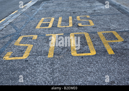 Bus Stop Sign Painted on Road Stock Photo - Alamy