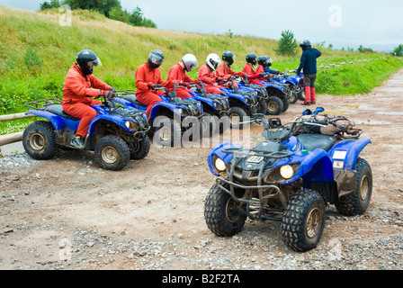 off-road quad bike wheel on a pile of rocks. off-road studded tire on ...