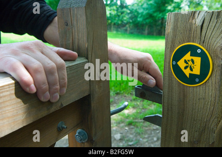 Hands opening a footpath gate Stock Photo - Alamy