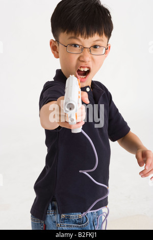 Portrait of boy with mouth open playing on snow Stock Photo - Alamy