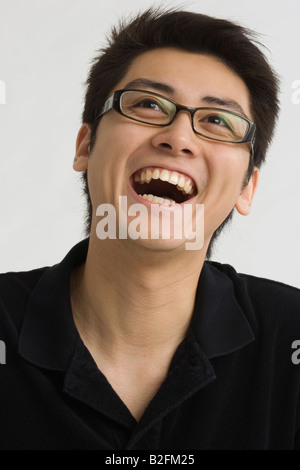 Close-up of a young man laughing Stock Photo - Alamy