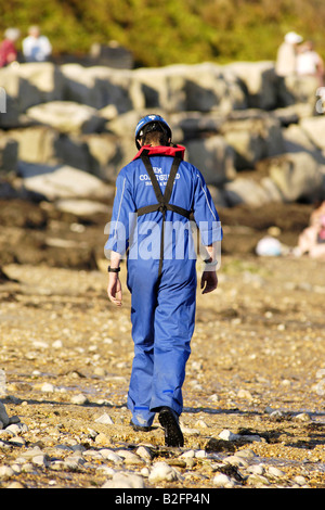 A member of HM Coastguard Search and Rescue wears a high visibility ...