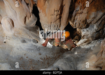 A narrow cave passage with a cave explorer Stock Photo - Alamy