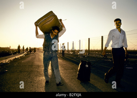 refugee man carrying all his luggage, during gulf crisis Stock Photo ...