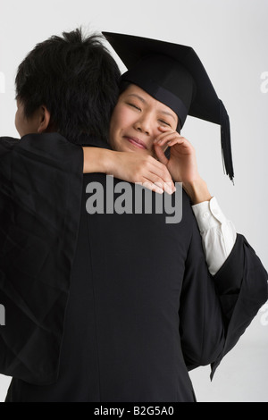 Education, graduation and crying with friends hugging in support or ...