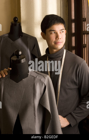 Young chinese man tailor smiling confident standing at atelier Stock ...
