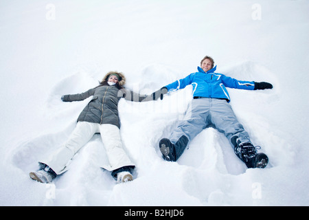 Couple doing snow angel Stock Photo: 96905294 - Alamy
