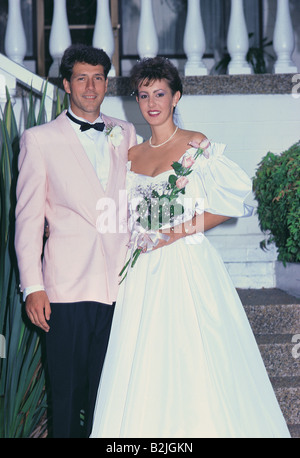 young couple groom with the bride on a sandy beach at a wedding walk ...