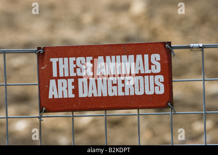 A sign at a zoo warning of dangerous animals Stock Photo - Alamy