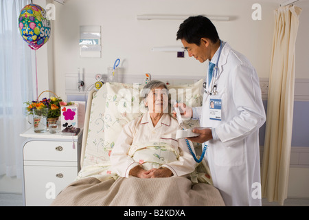 Asian female doctor holding flower speaking patient via video call ...