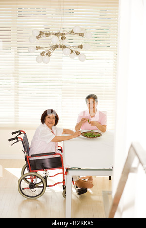 High angle portrait of black senior woman ironing clothes at home while ...