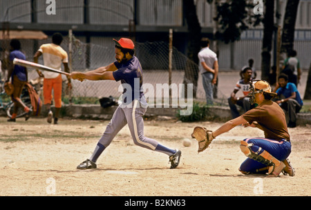Young hispanic man playing baseball holding bat doing ok gesture ...