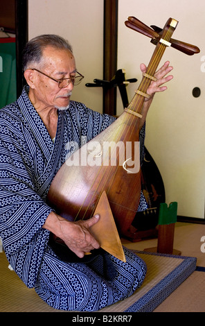 Asian man playing classic guitar isolated on white background in high ...