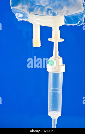 closeup of medical intravenous fluid drip chamber, hospital environment ...