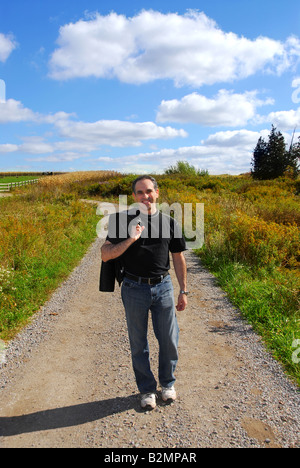 Country road towards green pasture Stock Photo - Alamy