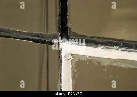 Office window that recently has had grout added to it Stock Photo - Alamy