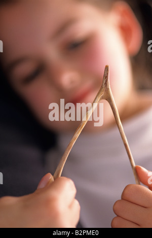 Mother and daughter pulling on a wishbone close up of hands Stock Photo ...