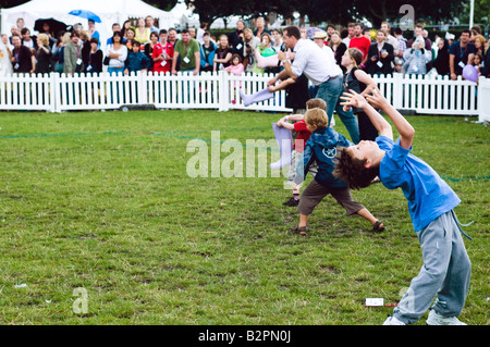 children compete in welly wanging competition at a london summer ...