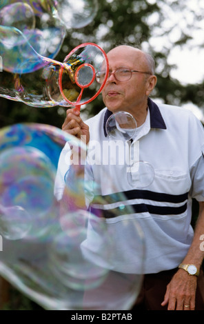 Senior Citizen blowing bubbles Stock Photo - Alamy