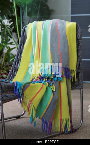 Throw draped over a chair Stock Photo - Alamy