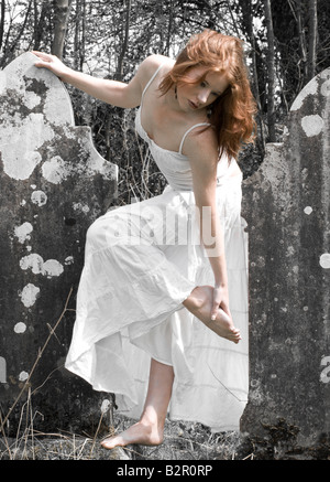 a beautiful woman in a white flowing long dress stay near a beautiful ...