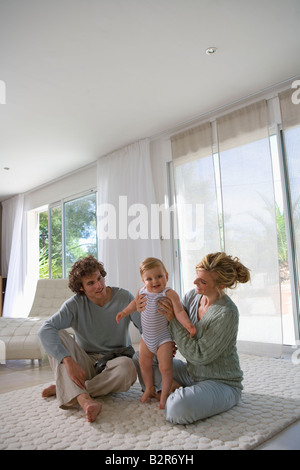 baby standing up with help of father s support Stock Photo - Alamy